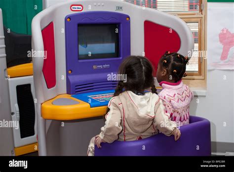 Two Year Old Prebabe Girls Using A Computer In The Classroom Stock Photo Alamy