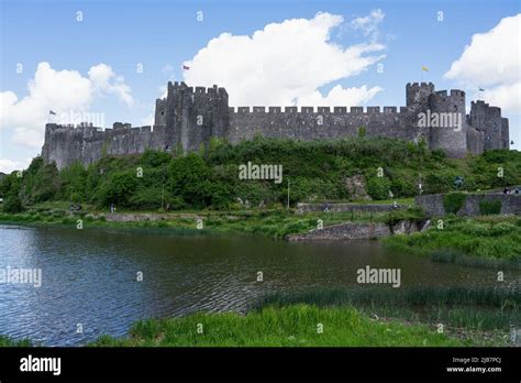 View Of Pembroke Castle Over Pembroke River Waterway Blue Sky Stock