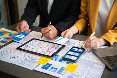Premium Photo Ux Developer And Ui Designer Brainstorming About Mobile App Interface Wireframe