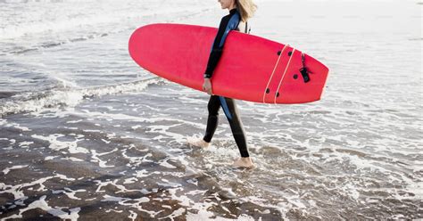 일몰에 아름 다운 야생 해변에서 서핑 보드와 함께 산책 잠수복을 입은 젊은 여자 수상 스포츠와 활동적인 라이프 스타일 개념 사진 Unsplash의 바다 이미지