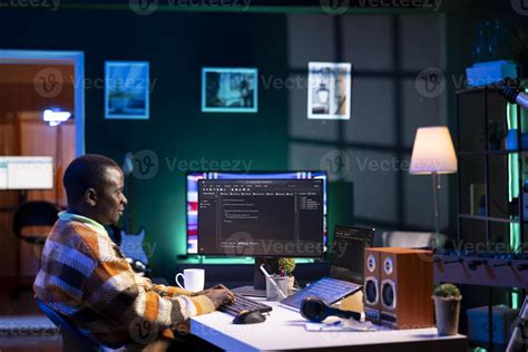 Programmer In Home Office Concentrating On Finding Bugs While He Codes