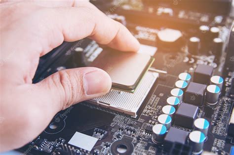 Premium Photo Technician Installing Cpu Chip Microprocessor To Socket On Motherboard
