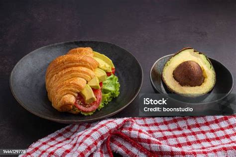얇게 썬 아보카도 토마토 양상추를 곁들인 크루아상 빈티지 배경의 검은 접시에 아보카도 반쯤 0명에 대한 스톡 사진 및 기타 이미지 Istock
