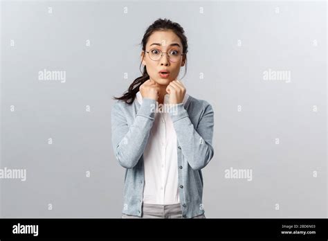 Timid And Shy Asian Girl In Glasses Brunette Hair Combed Hold Hands