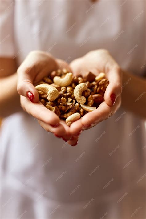 Premium Photo Hands Holding Nuts