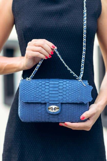 Premium Photo Girl Holding A Bag Made Of Exotic Python Skin