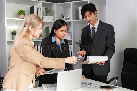 Business Team Collaborating On Data Analysis With Graphs In A Modern