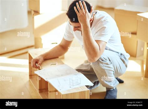 Frustrated Man Reading Instruction And Assembly Furniture Diy New