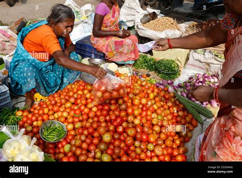 Vendor Using Single Use Plastic Bags In The Vegetable Market In Madurai Tamil Nadu India Stock