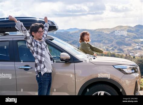 Man And Woman Getting Out Of Car And Stretching Stock Photo Alamy