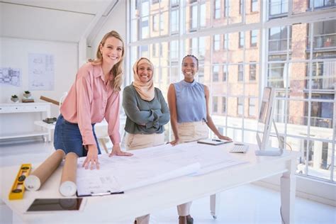 Premium Photo Teamwork Architecture And Portrait Of Women In Office Standing By Desk With
