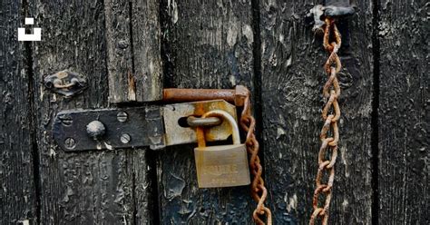 Brown Padlock On Black Wooden Door