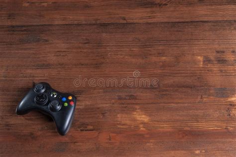 There Is A Gaming Controller On The Table By Himself And He Is Next To