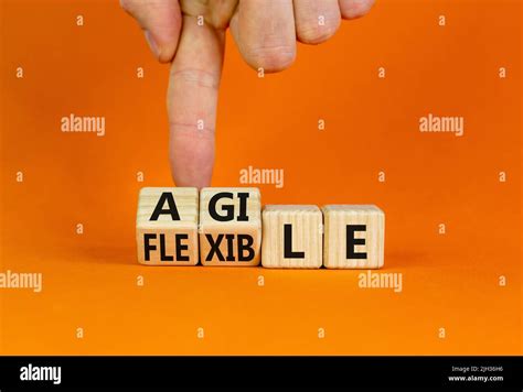 Flexible And Agile Symbol Concept Words Flexible And Agile On Wooden Cubes Businessman Hand