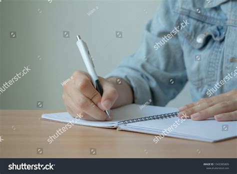 Female Hand Pen Writing On Notebook Stock Photo Shutterstock