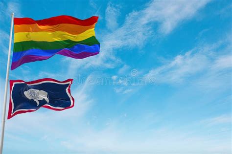 Large Lgbt Flag And Flag Of Wyoming State Usa Waving In The Wind At