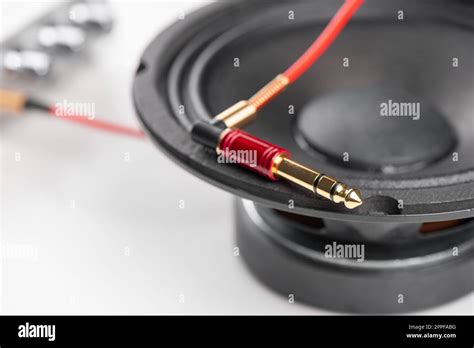 Close Up Red Aux Auxiliary Cable With Male Jack With Speaker In The