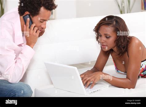 Couple On Laptop And Phone Stock Photo Alamy