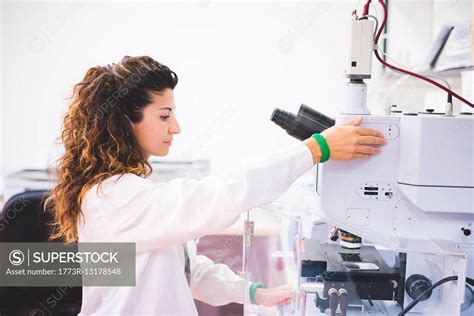 Female Scientist Using Ftir Spectrophotometer Focusing Sample On Microscope Camera Superstock