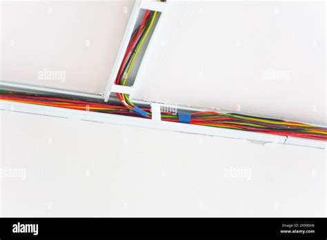 Exposed Colourful Cables On Electrical Wire Casing Base For Rewiring Purpose Is Layout Neatly On
