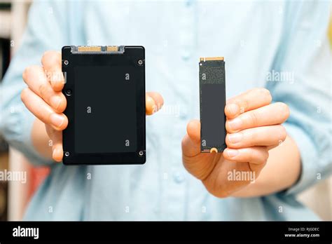 Woman Hands Holding New NVME PCIE SSD Hard Drive Disk With High Read And Write Speed Comparing