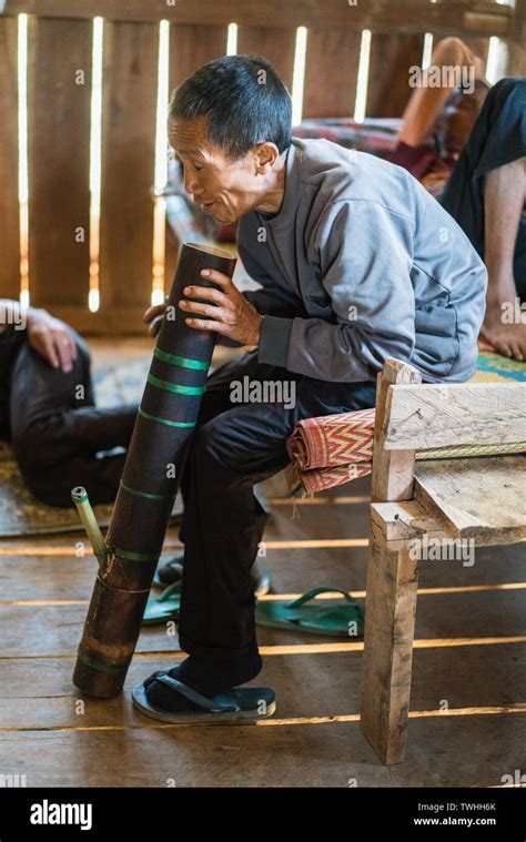 Man Smoking Opium By Traditional Tobacco Pipe In The Akha Pixor Village