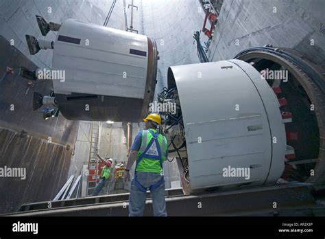 A Tunnel Boring Machine Tbm Is Lowered Down An Access Shaft Before Being Assembled And