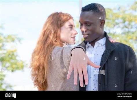 African Black Man And Redhead Caucasian Woman Showing An Engagement