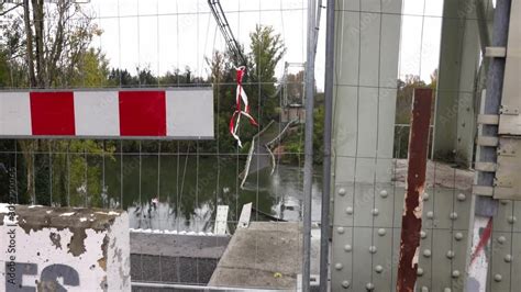 Barrier With Red White Stripes Blocks Access To The Cliff Into The River In A Dangerous Place