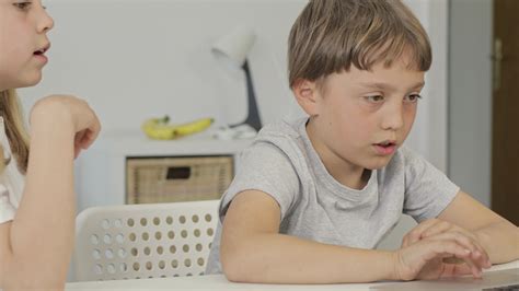 Brother Helps His Younger Sister To Make Her Homework 27159804 Stock