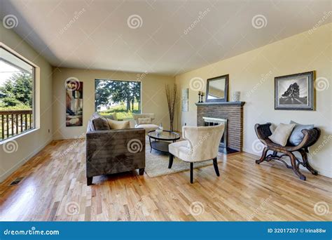 Living Room With Hardwood Floor Fireplace And Large Windows Stock