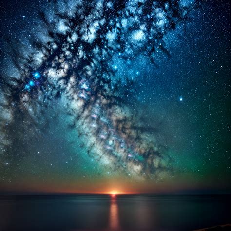 A Sea Of Stars Mirrors The Oceans Depth On A Calm Night By The Beach