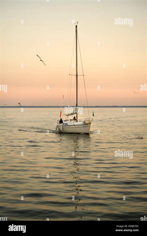 Yacht With Sails Down Entering Oakville Marina On Lake Ontario Stock