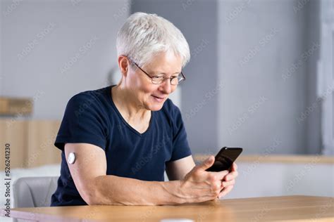 Woman Testing Glucose Level With Continuous Glucose Monitor Stock Photo Adobe Stock