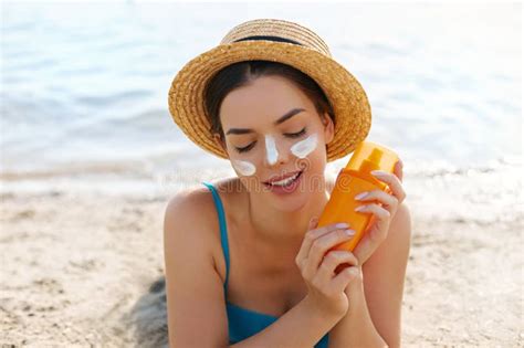 The Girl Uses A Sunscreen For Her Skin Portrait Of A Female Holding