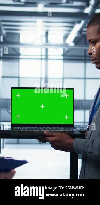 Vertical Video Engineering Team In Data Center Using Green Screen Laptop Implementing