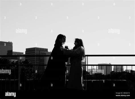 Biracial Couple Sharing Coffee On Tokyos Imperial Palace Grounds In