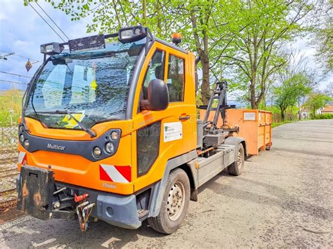 An Orange Garbage Collector Stands On The Side Of The Road For Branches Editorial Stock Image