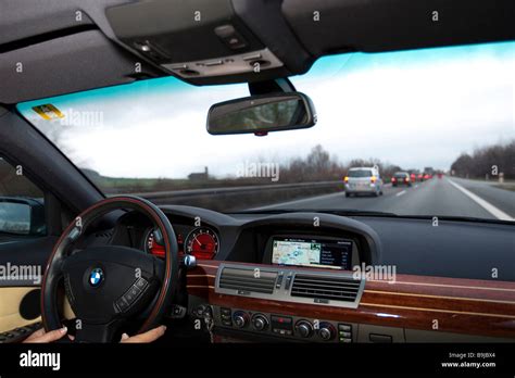Woman Driving A Car With A Navigation Assistant On The Right Lane Of A