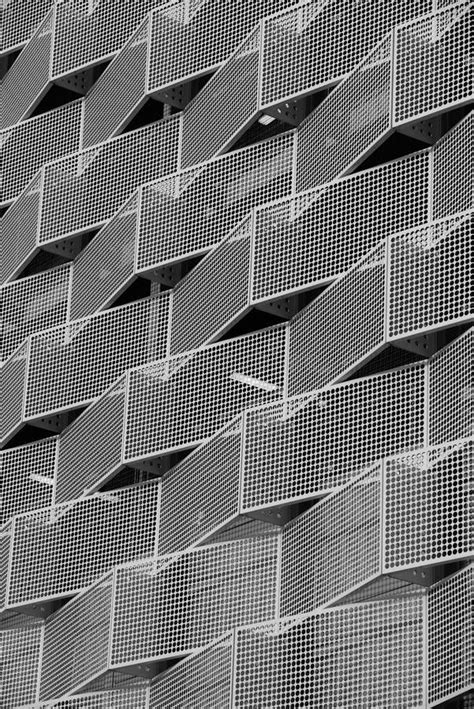 Modern Steel Cladding With Angular Geometric Patterns And Square Holes In A Shiny Metal Stock