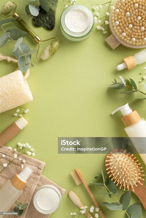 지속 가능한 자기 관리 개념 파스텔 그린 표면에 스킨케어 필수품 나무 브러시 수건 칫솔 유칼립투스 등을 담은 평평한 수직 평면도