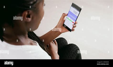 Woman Testing Glucose Level With Continuous Glucose Monitor On Mobile Phone Stock Photo Alamy