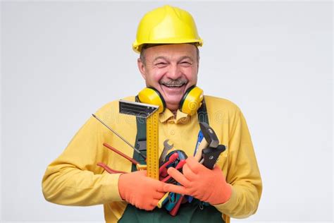 Laughing Senior Hispanic Plumber Holding Tools In Hands Stock Image