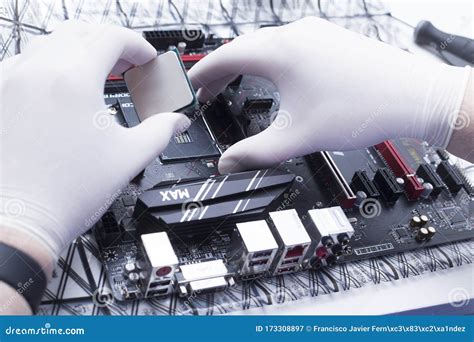 Hands Of A Technician Assembling Computer Hardware Parts New Cpu Is