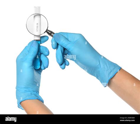 Scientist With Magnifying Glass Examining Test Tube With Label Covid 19
