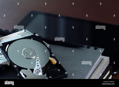Close Up Of Open Computer Hard Disk Drive On Desk And Notebook Stock Photo Alamy