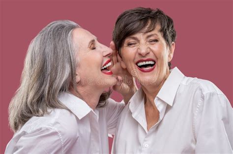 Two Well Dressed Women Looking Enjoyed And Having Fun Stock Photo