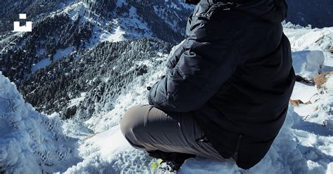 검은 재킷과 흰색 니트 모자를 쓴 사람이 낮에 눈 덮인 산에 서 있다 사진 Unsplash의 무료 숲 이미지