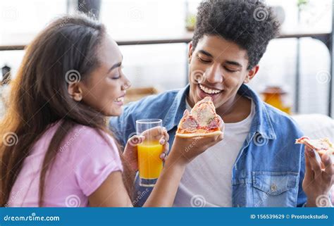 Lovely African American Couple Sharing Pizza On Date At Home Stock Image Image Of Meal Happy