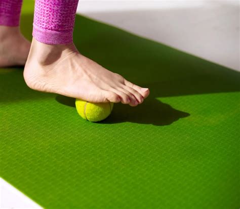 Premium Photo A Tennis Ball Under Female Foot Massage For Relieve